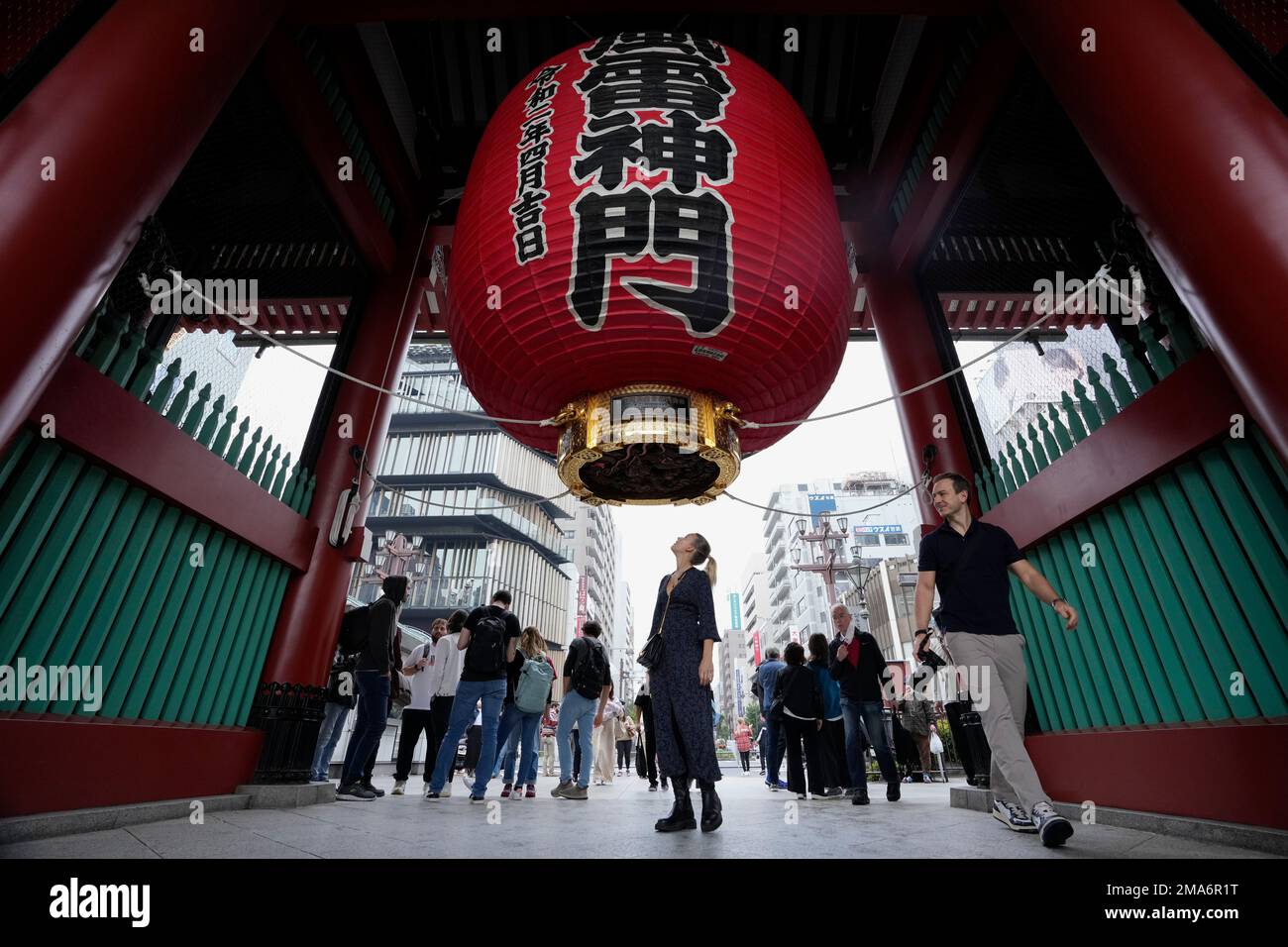 A foreign tourist looks up to see the inside of the famed lantern at ...
