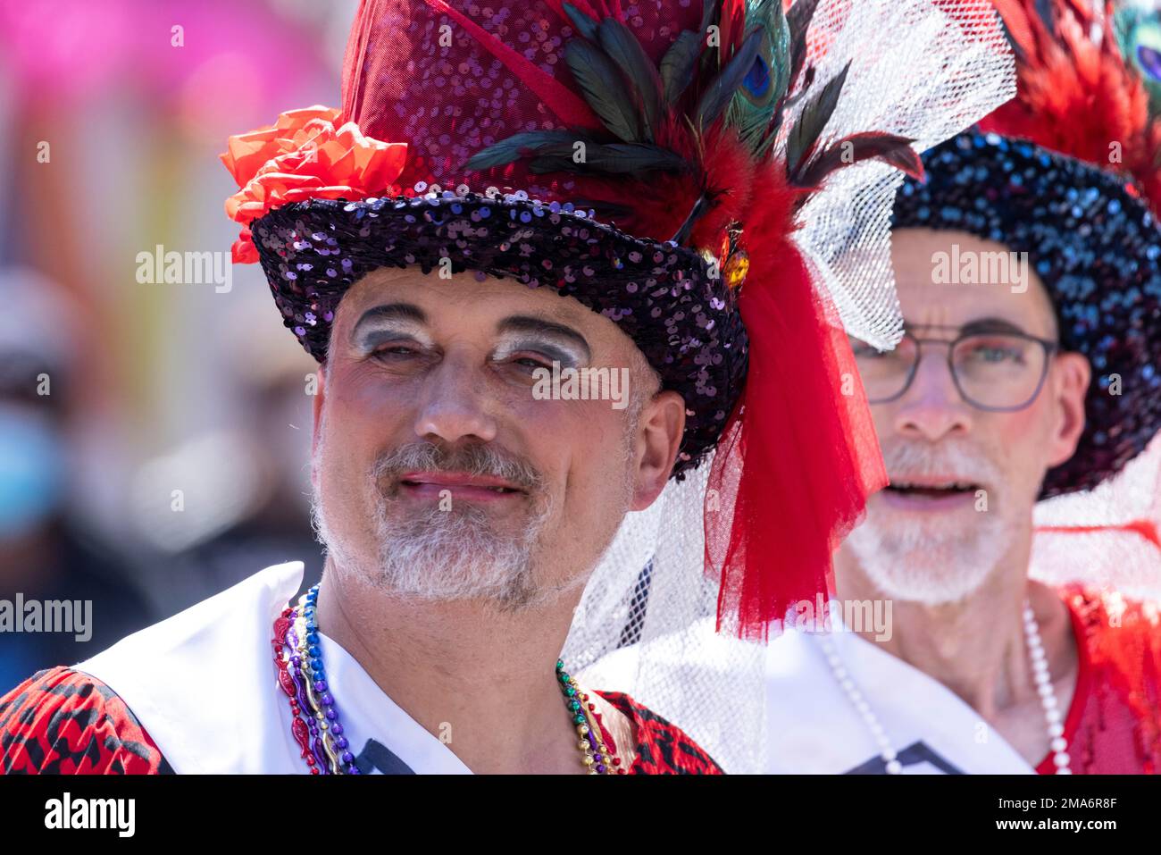 2 costumed and made-up men with colourful hats at the CSD parade ...
