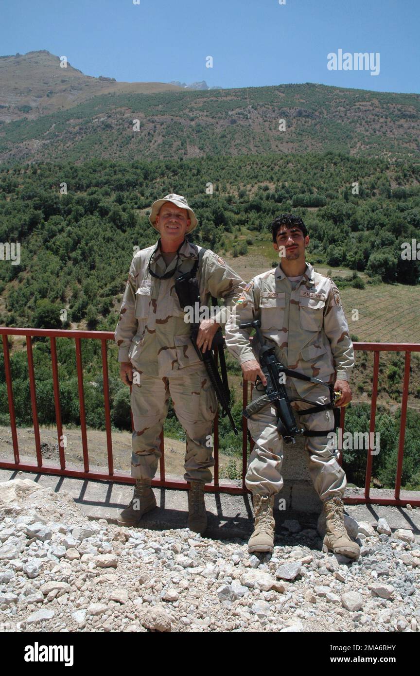 US Army (USA) Sergeant First Class (SFC) Charles Holt (left) and ...