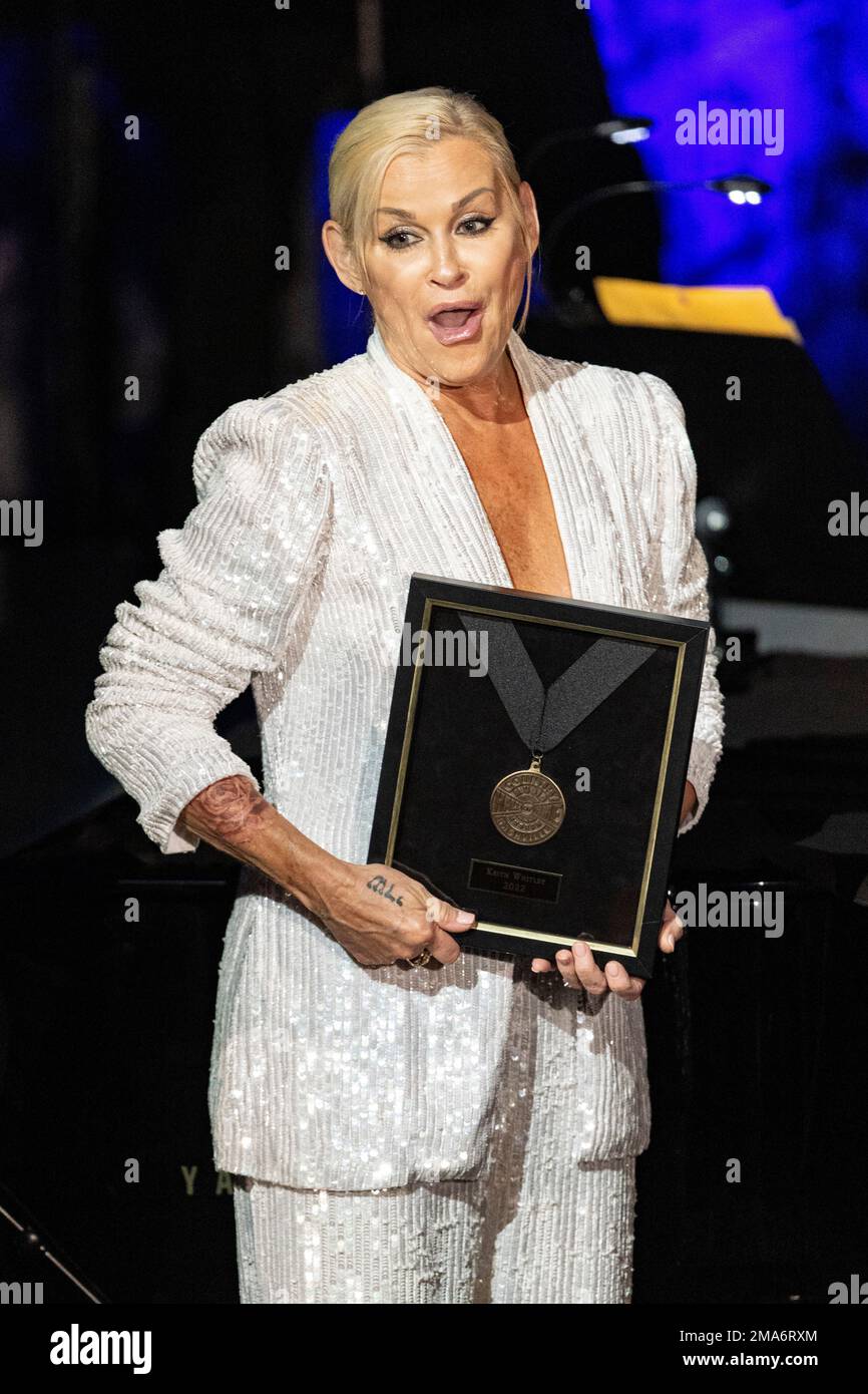 Lorrie Morgan holds the medallion accepted on behalf of late husband ...