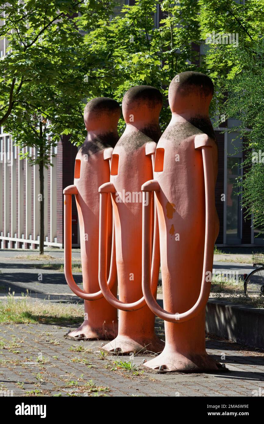 Three human petrol pumps refuelling themselves, sculpture Tankmal by ...