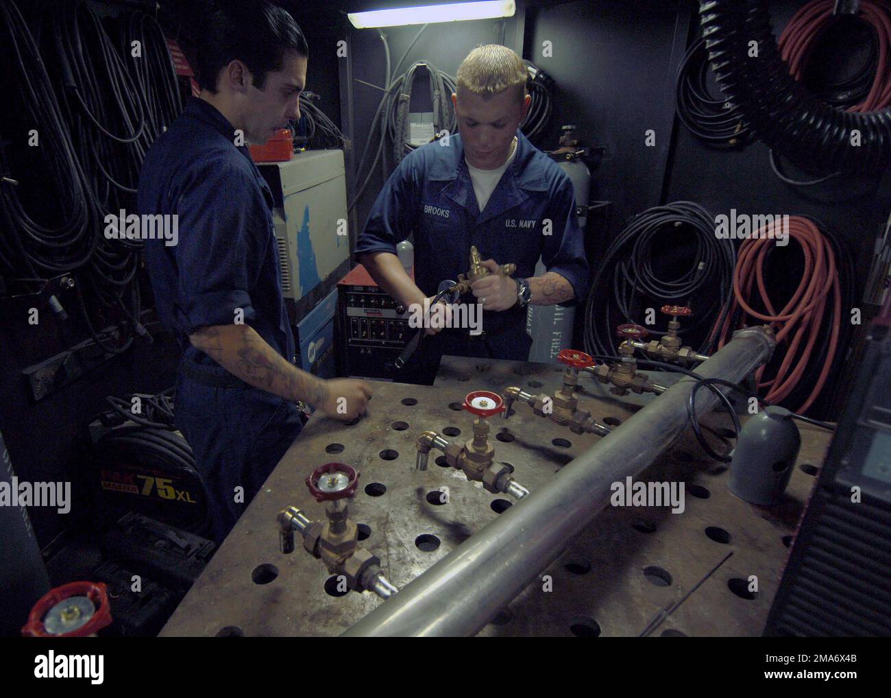 US Navy (USN) Firemen (FN) Steven Irwin (left), and Chance Brooks weld ...