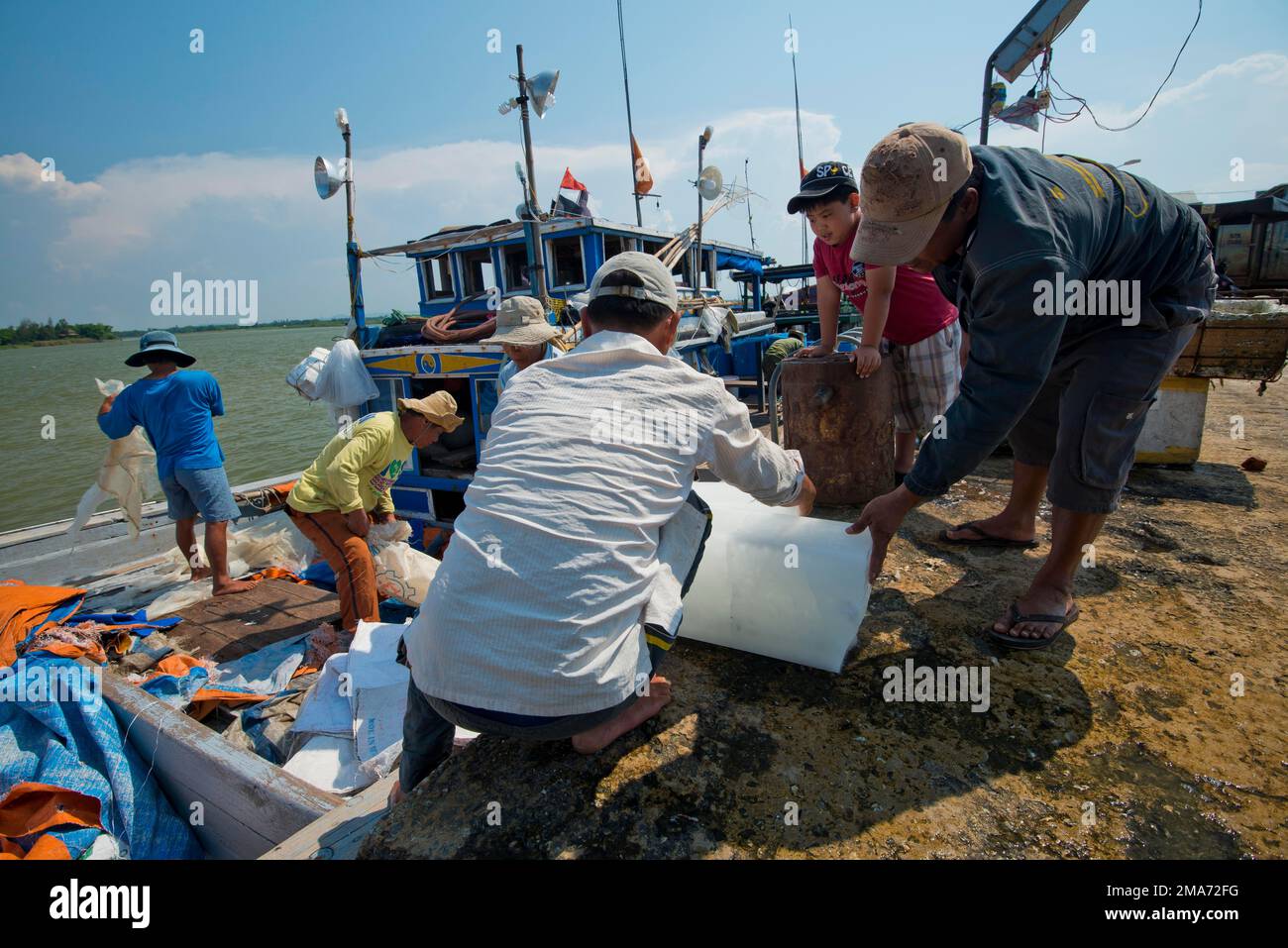 Small fishing pier on the Thu Bon River where a fishing boat is ...