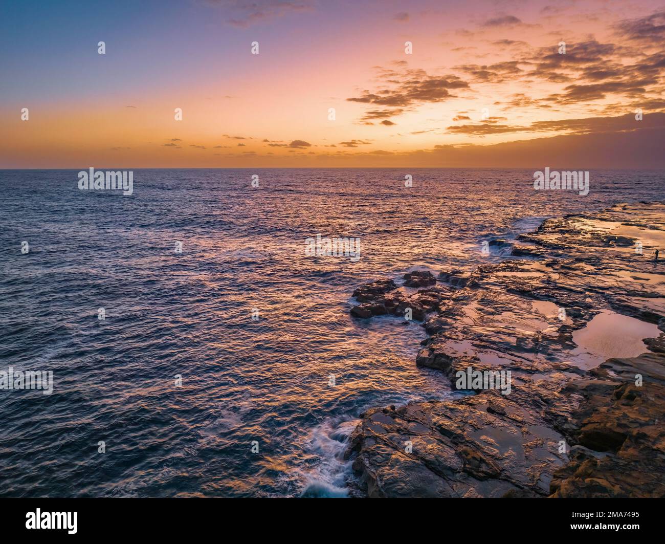 Aerial sunrise at the seaside and rock platform at Avoca Beach on the ...