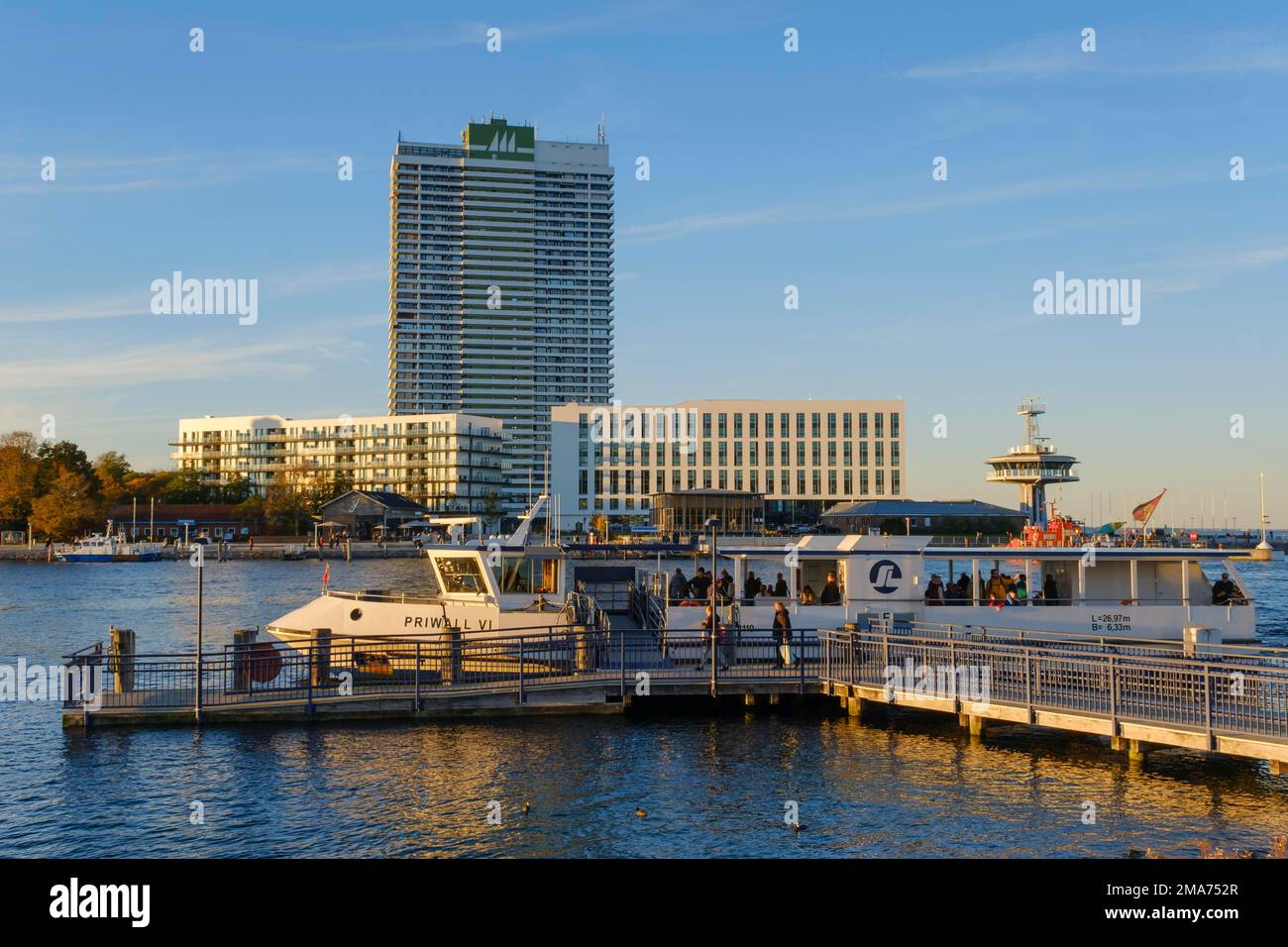 Passenger ferry at Priwall, behind Hotel Maritim and pilot station ...