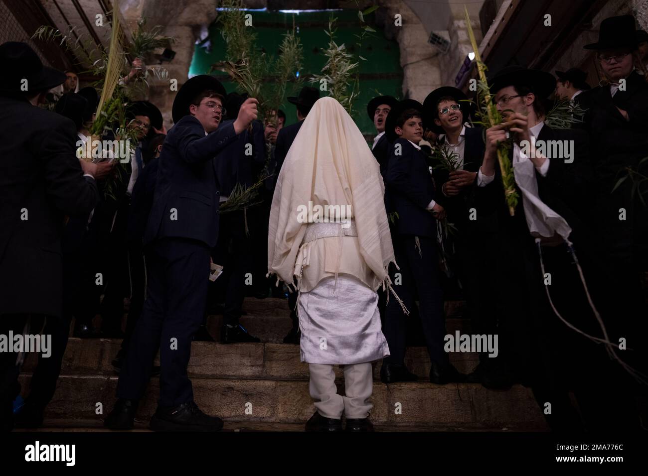 Ultra-Orthodox Jews, one wearing prayer shawls perform the Hoshana ...
