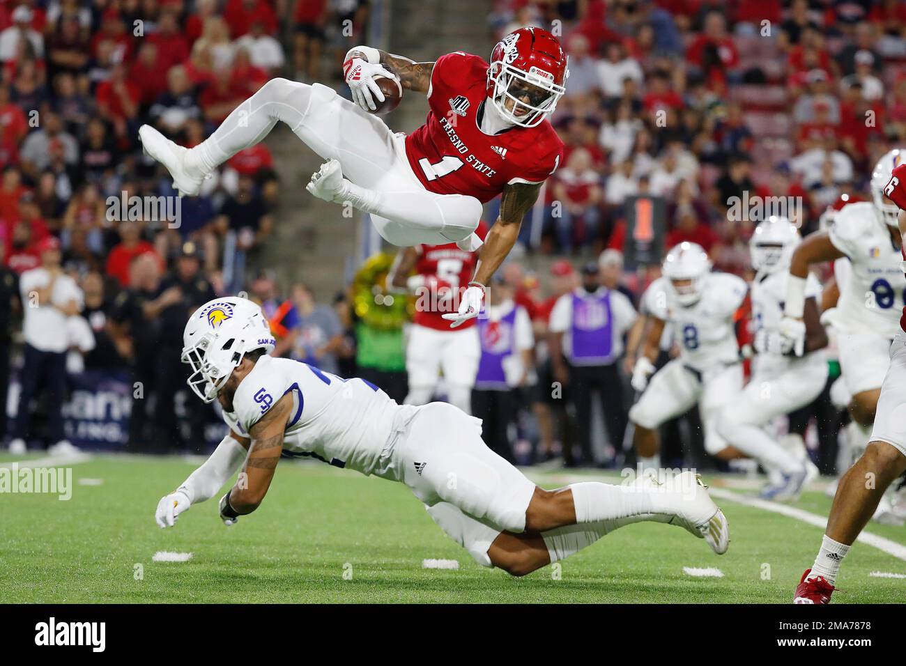 Fresno State wide receiver Nikko Remigio tries to hurdle San Jose State ...