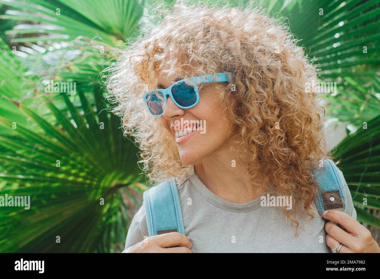 Portrait of young adult cheerful woman with a smile wearing blue ...
