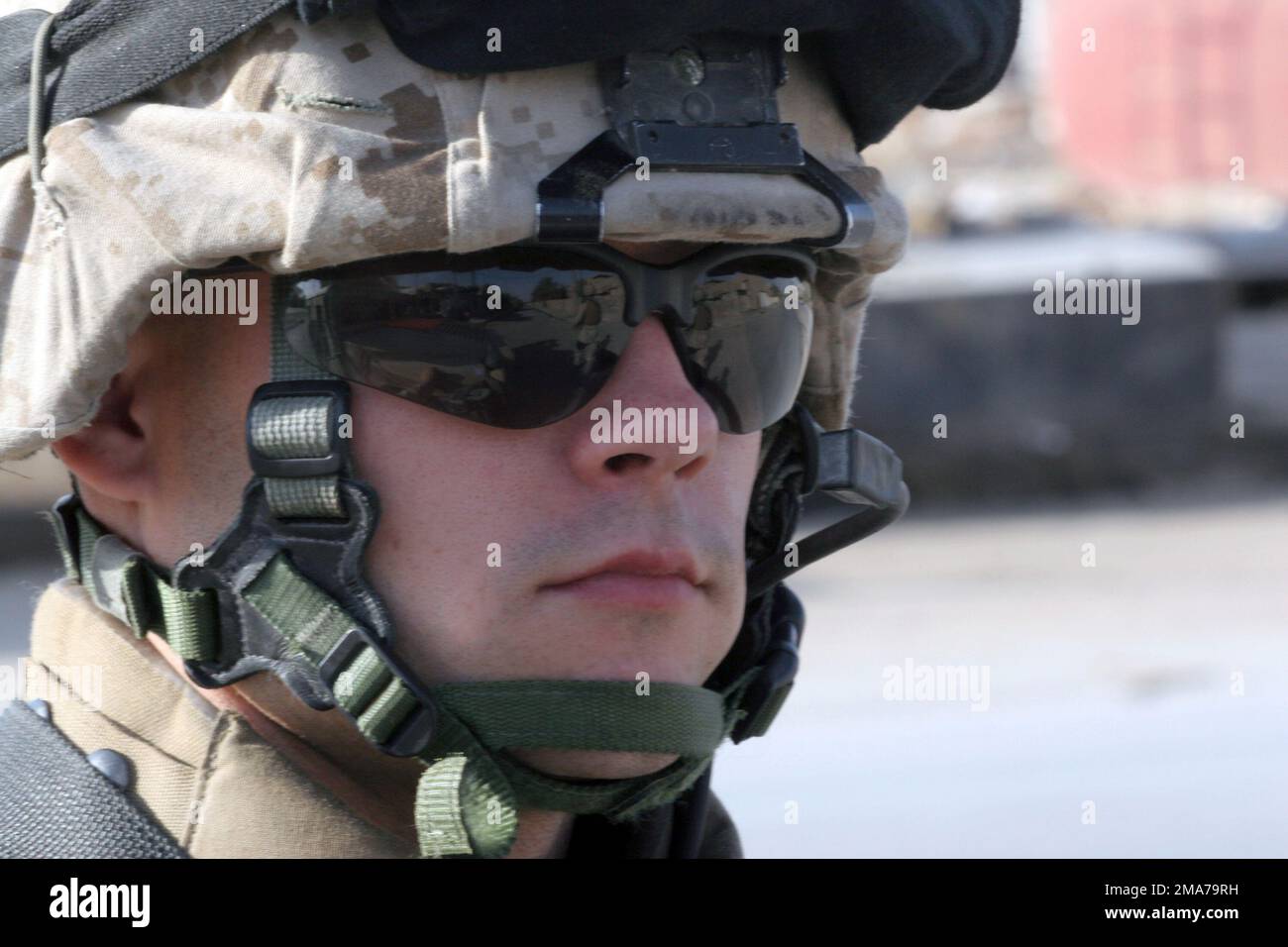 A US Marine Corps Marine watches as citizens of Fallujah, Iraq, prepare ...