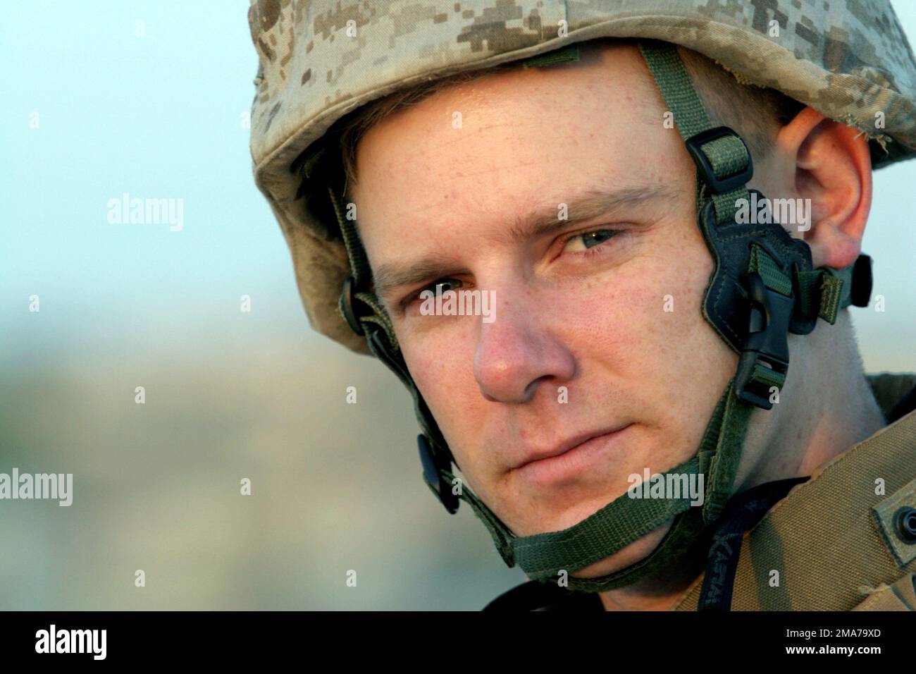 A US Marine Corps Marine watches as citizens of Fallujah, Iraq, prepare ...