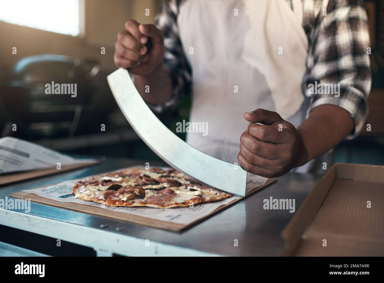 Working on the perfect slices. an unrecognizable man standing and ...