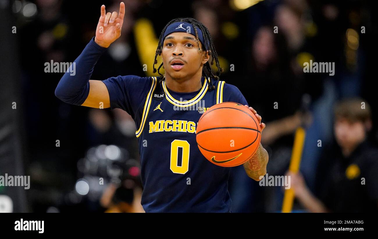 Michigan guard Dug McDaniel drives up court during an NCAA college ...