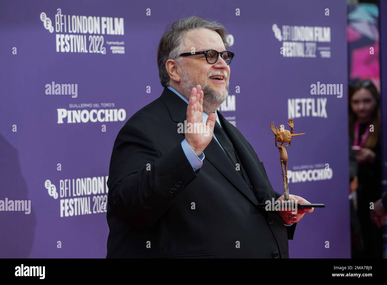 Director Guillermo del Toro poses, with a model of the character ...