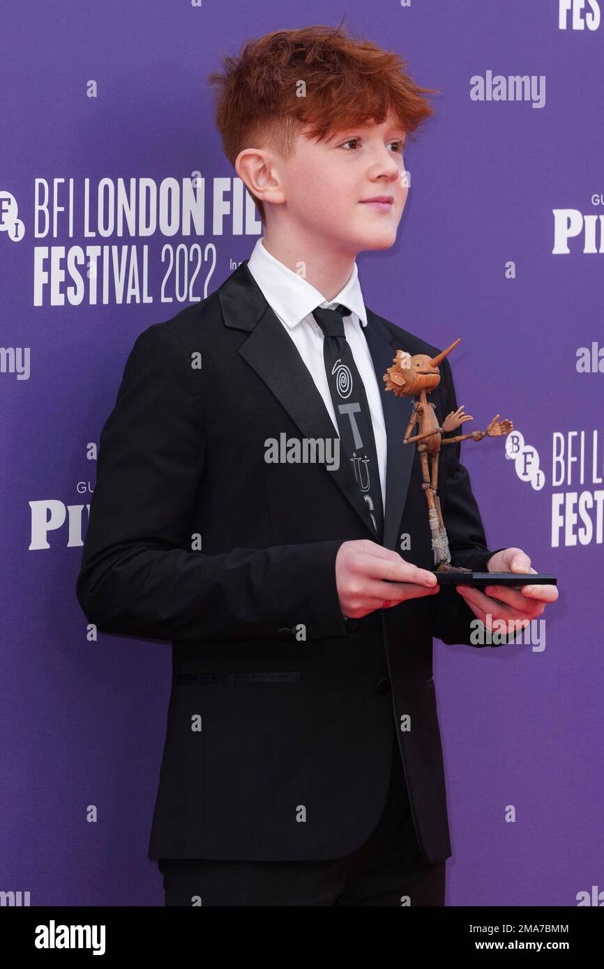 Gregory Mann poses, with a model of the character Pinocchio, for ...