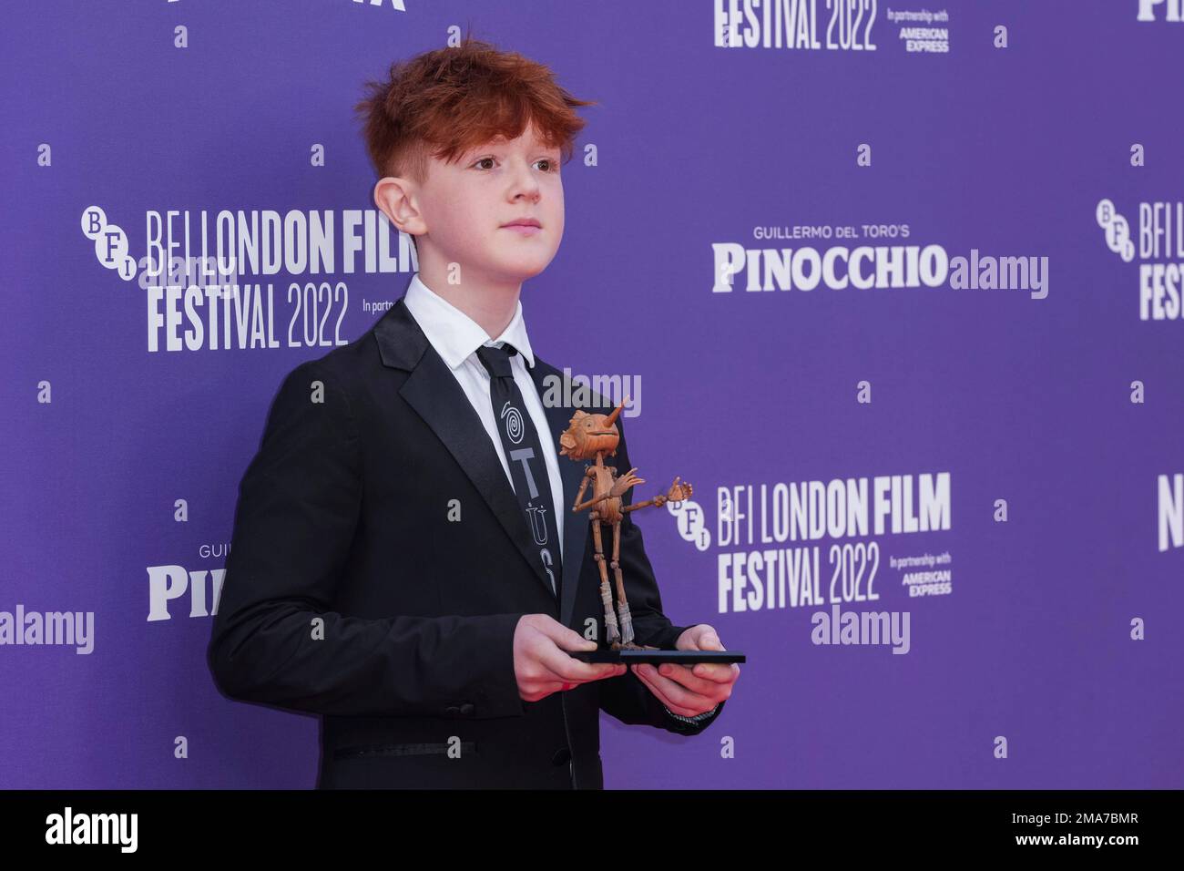 Gregory Mann poses, with a model of the character Pinocchio, for ...