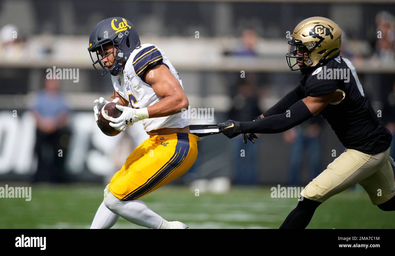 Colorado cornerback Kaylin Moore, right, pulls down California running ...