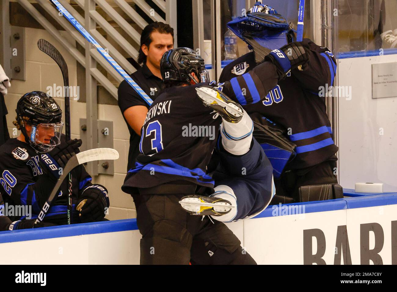 Bentley forward Matt Gosiewski (13) sends Maine forward Michael ...