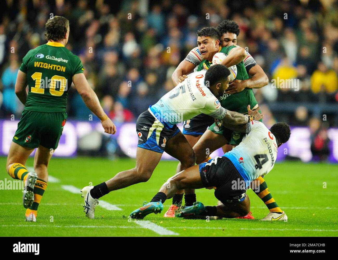 Australia's Latrell Mitchell, top right, is tackled by Fiji's Brandon ...