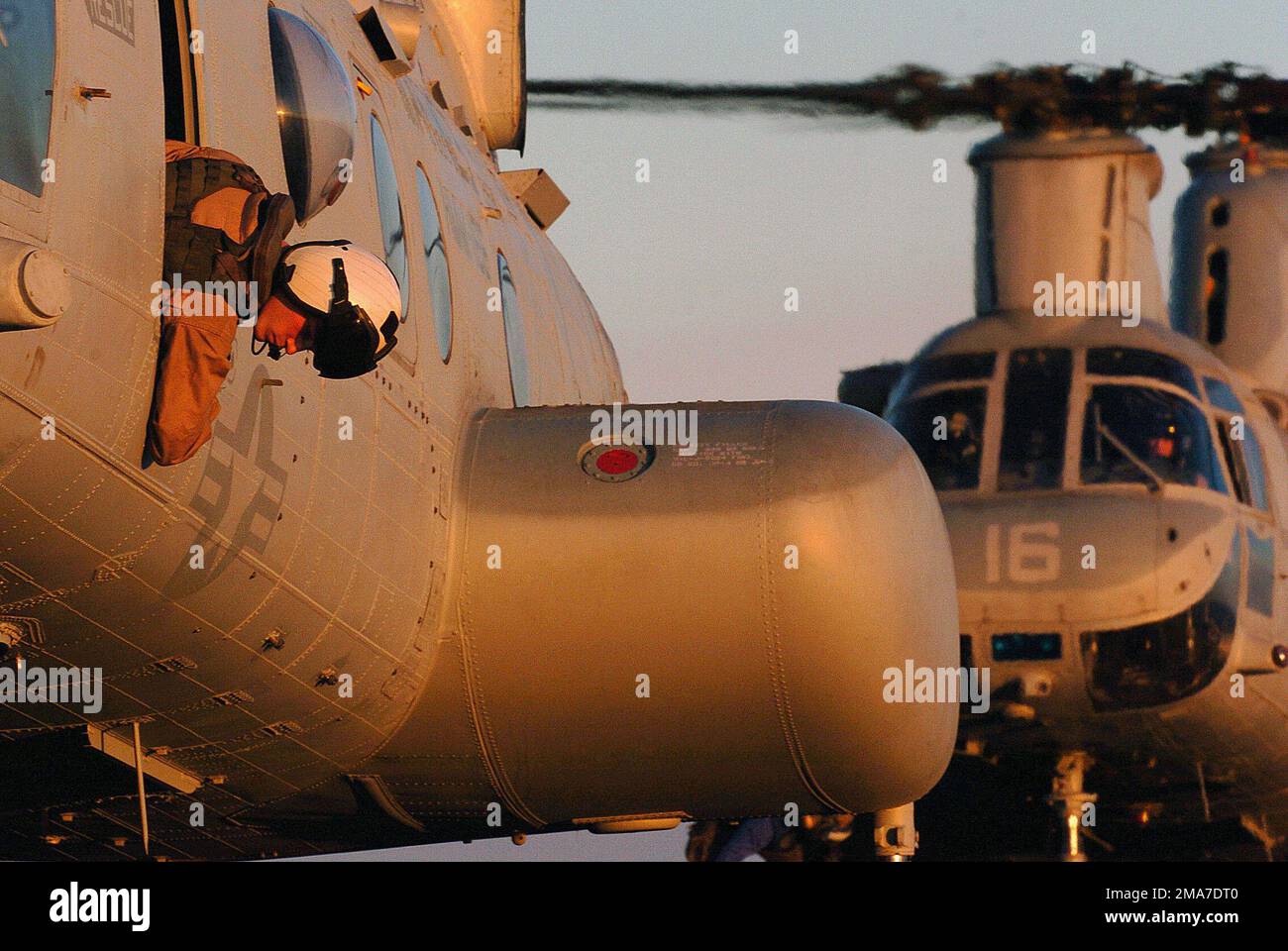 A US Marine Corps (USMC) crew member of a USMC CH-46E Sea Knight ...