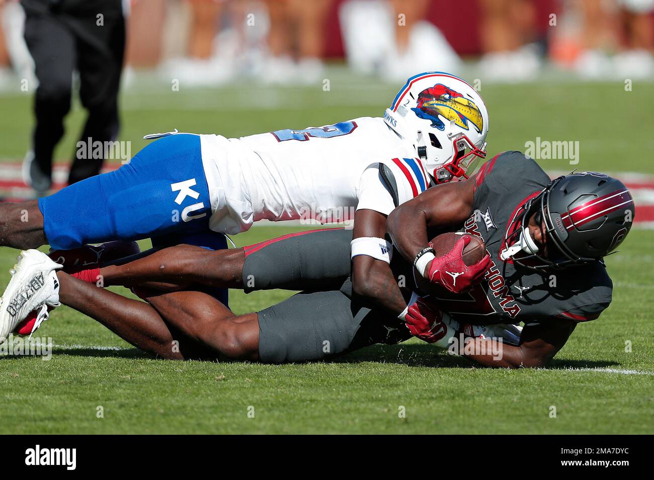 Kansas cornerback Cobee Bryant (2) tackles Oklahoma wide receiver ...