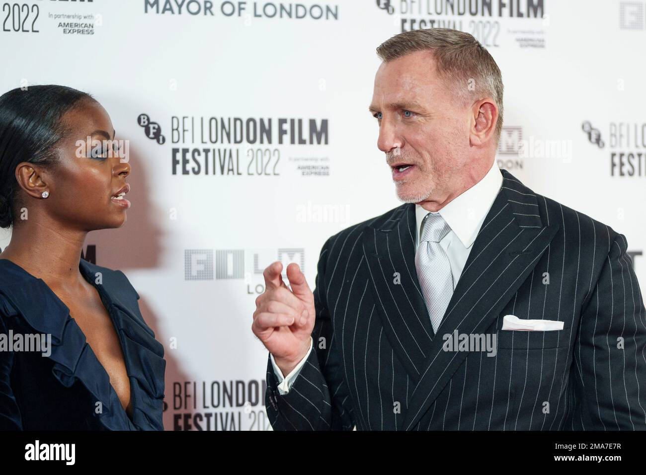 Danielle Deadwyler, left, and Daniel Craig speak with each other upon ...