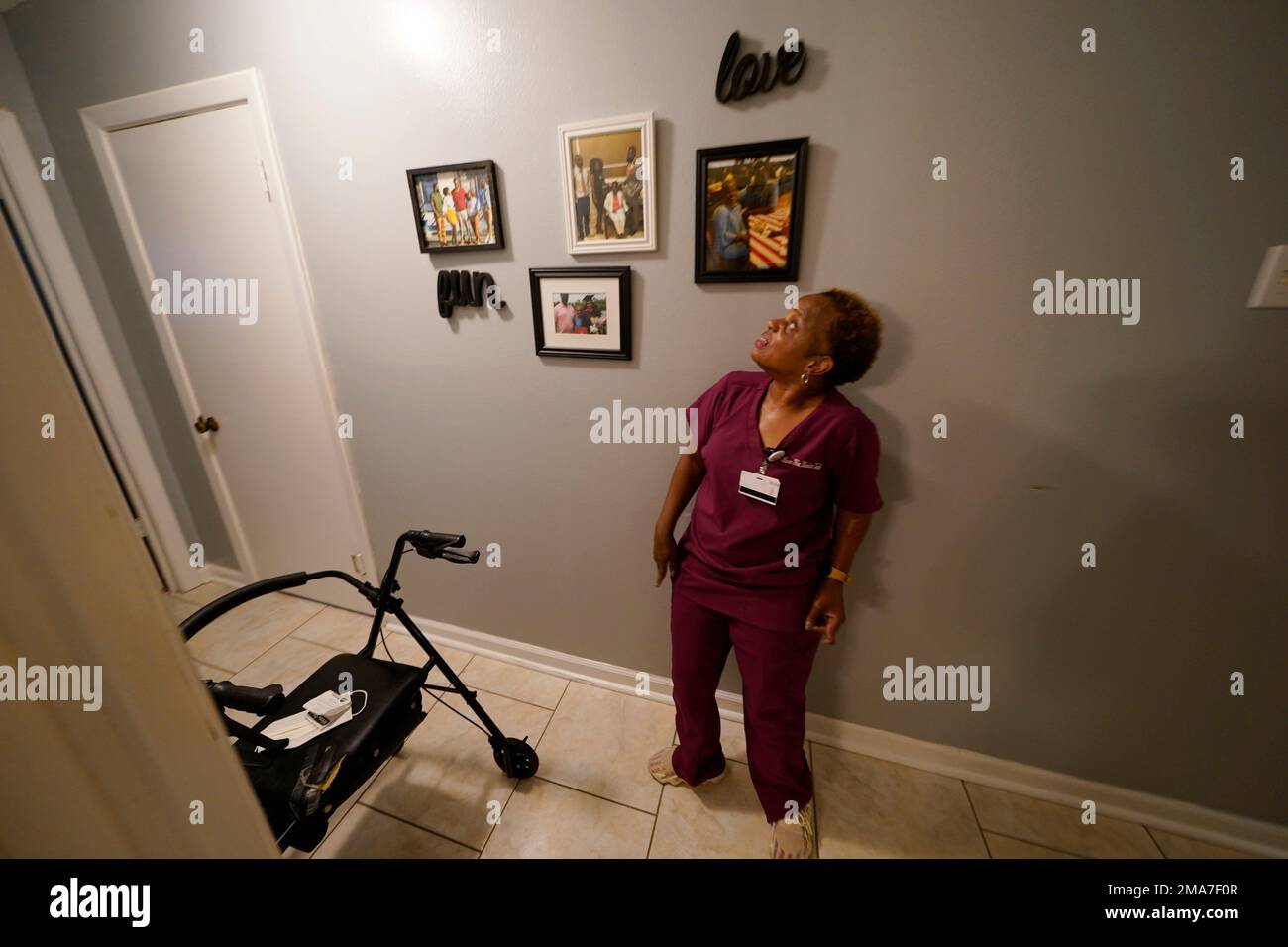 Karen Nix shows her family photos before leaving home for her evening ...