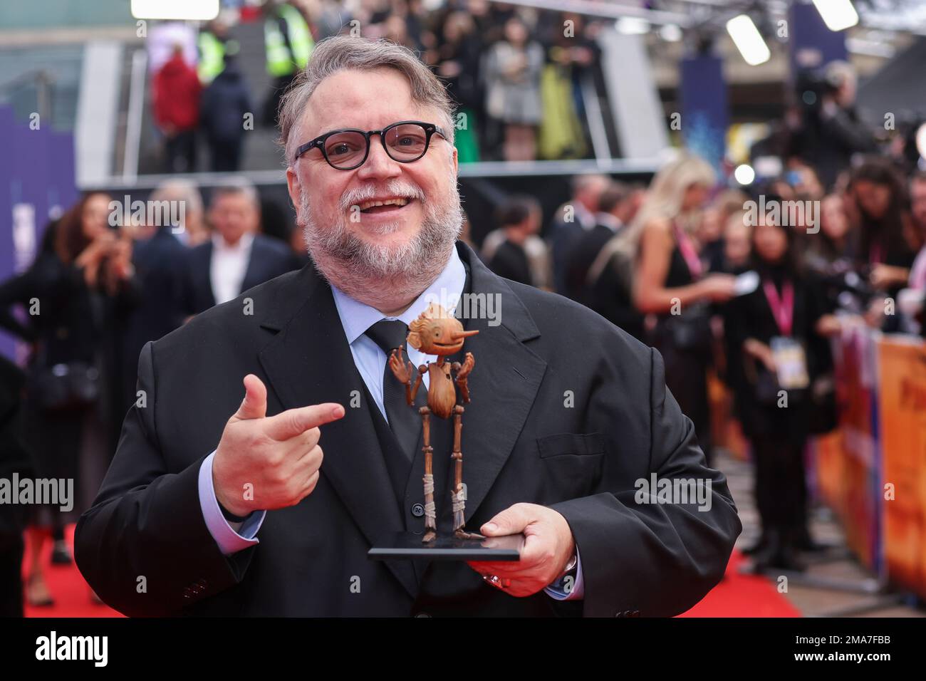 Director Guillermo del Toro poses, with a model of the character ...