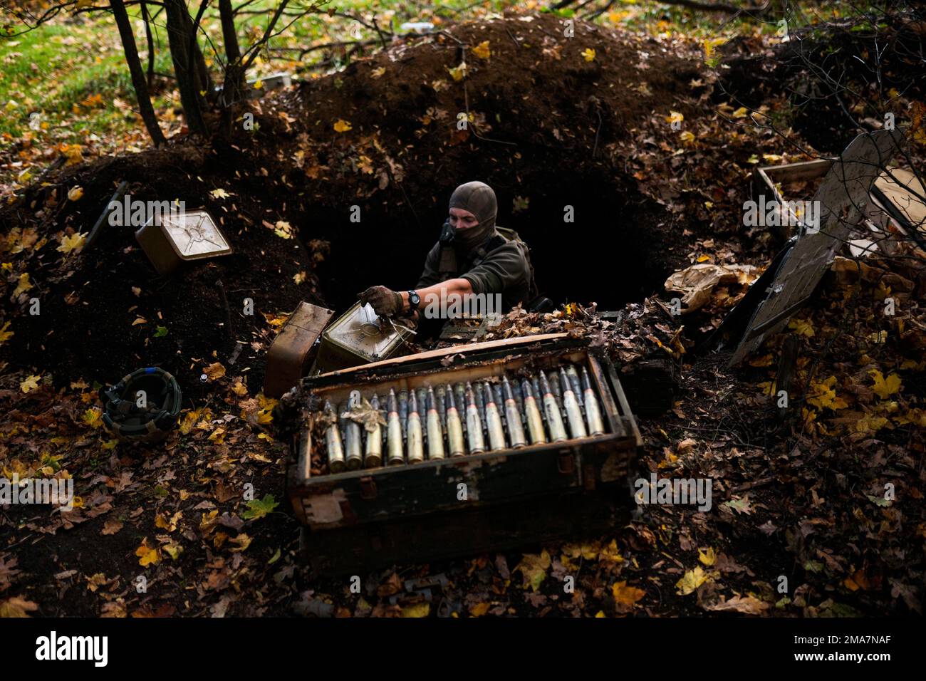 A Ukrainian territorial defence deminer takes Russian ammunition left ...