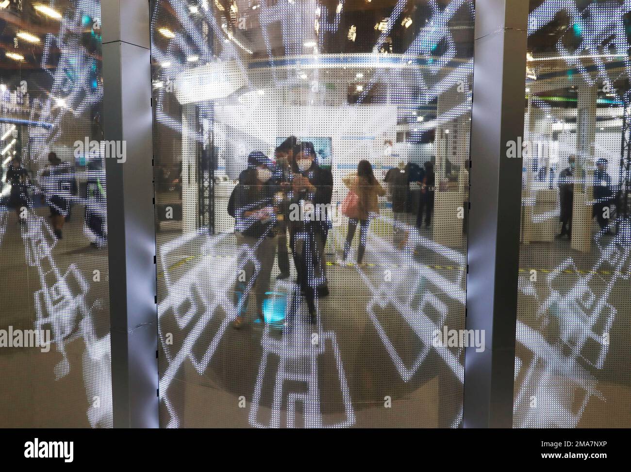 Visitors watch a transparent multi-curved interactive LED display ...