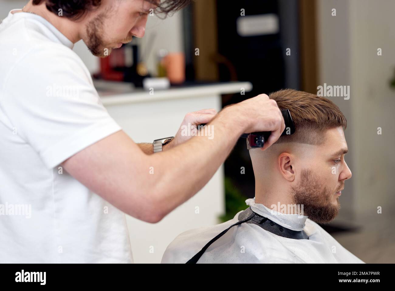 Barber making hairstyle confident hi-res stock photography and images ...