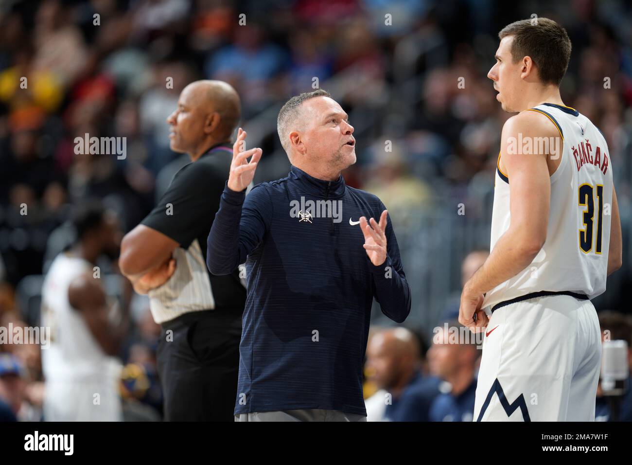 Denver Nuggets head coach Michael Malone () directs forward Vlatko ...