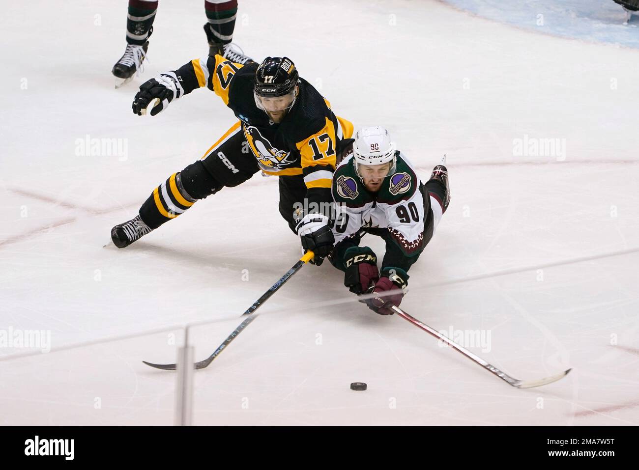 Pittsburgh Penguins' Bryan Rust (17) and Arizona Coyotes' J.J. Moser ...