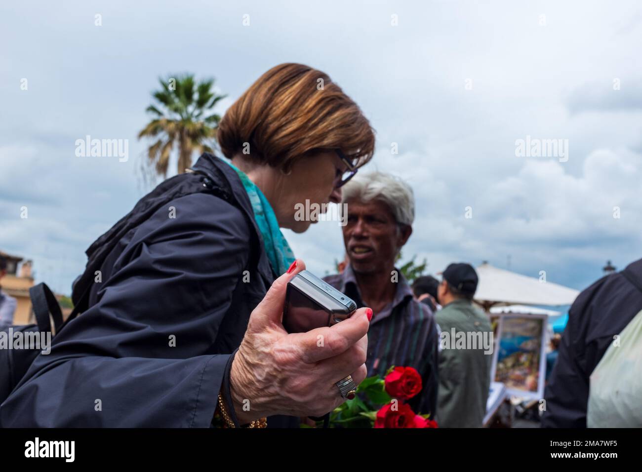Woman avoiding man selling flowers, People in Rome the Italian capital ...
