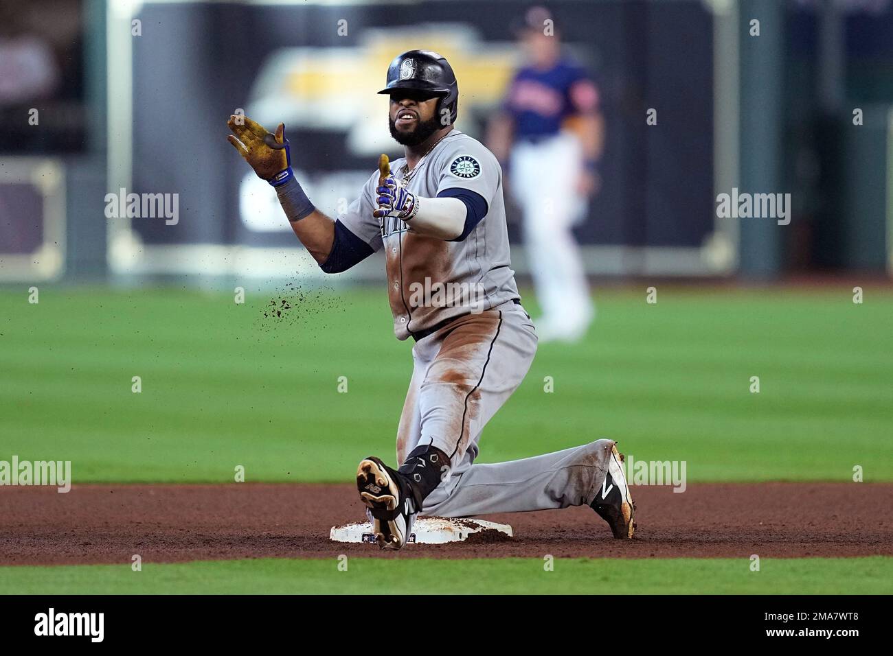 Seattle Mariners first baseman Carlos Santana reacts after he doubled ...