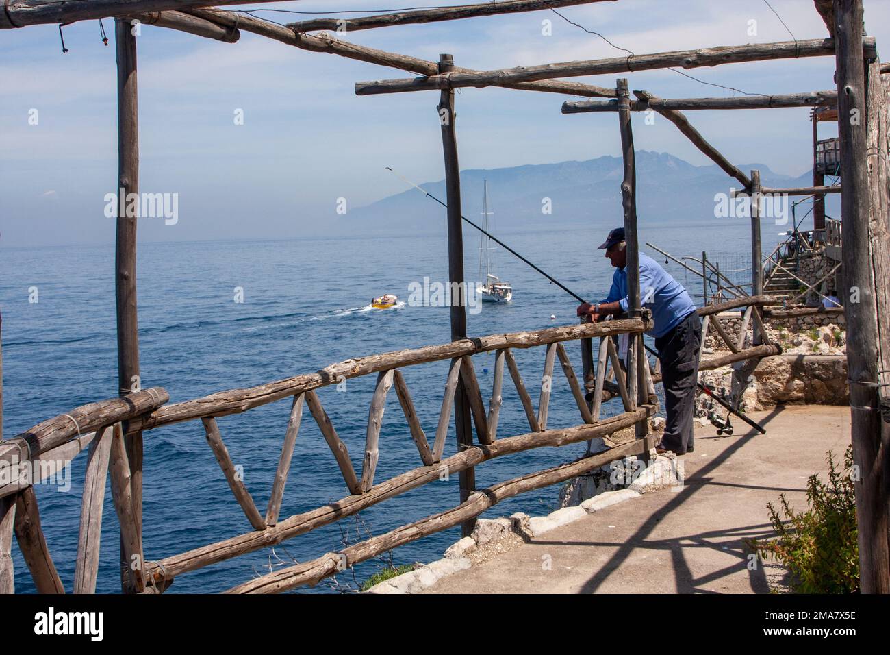 Fisherman with a rod Villa San Michele -Italy Stock Photo - Alamy