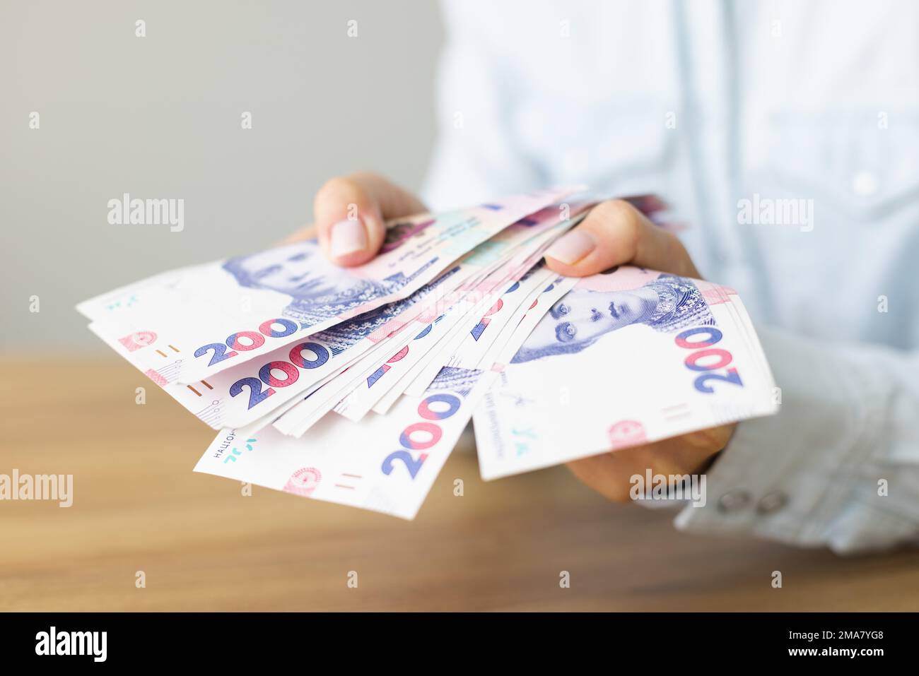 Woman propose Ukrainian 200 bill banknotes. Ukrainian money Stock Photo ...