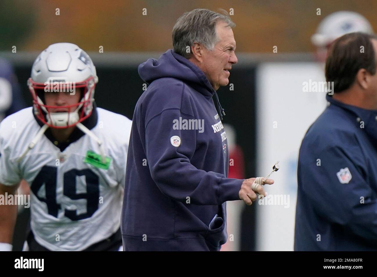 New England Patriots head coach Bill Belichick, center, walks on the ...