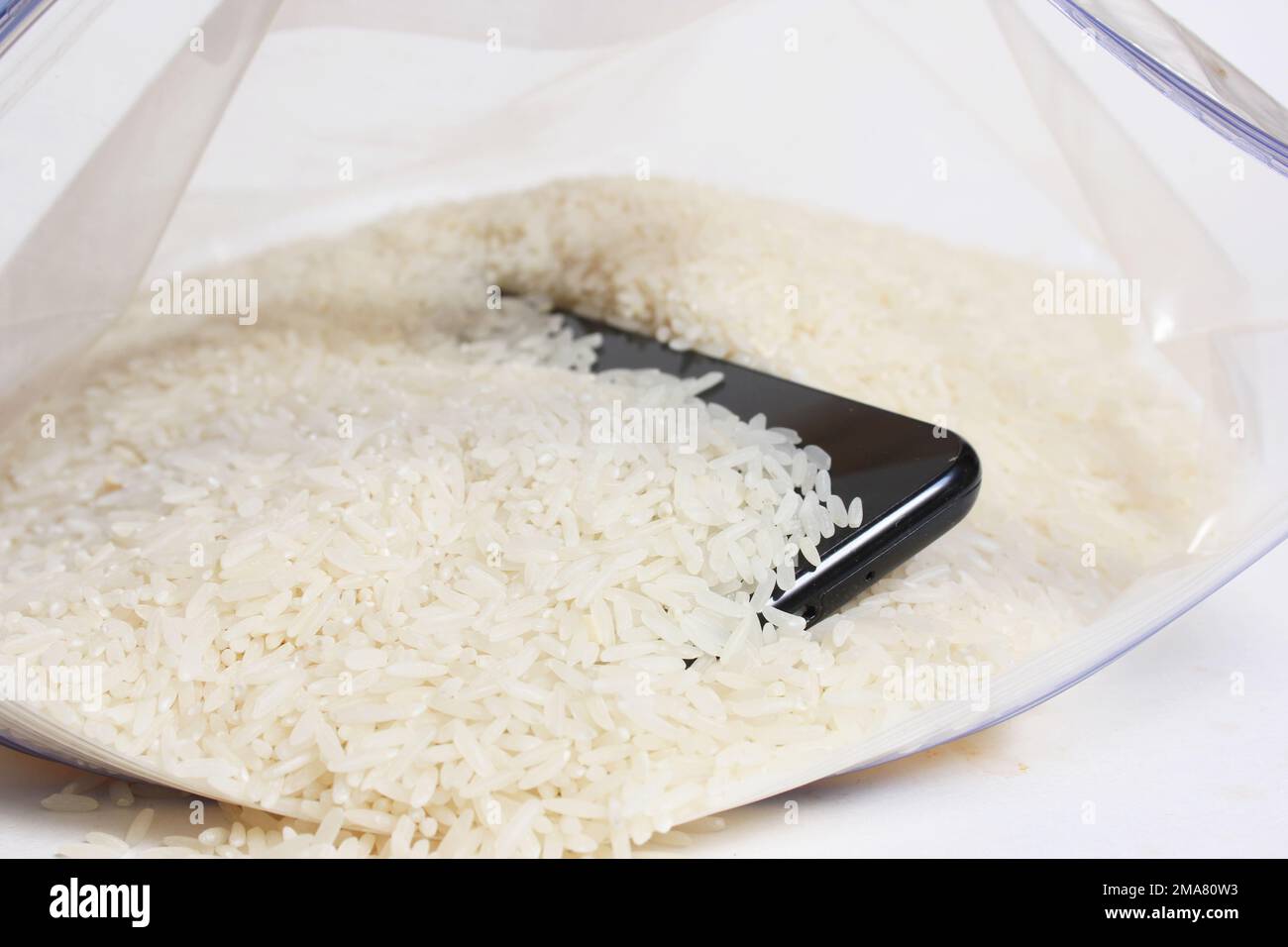 Smartphone in Bag of Rice to remove water from phone Stock Photo - Alamy