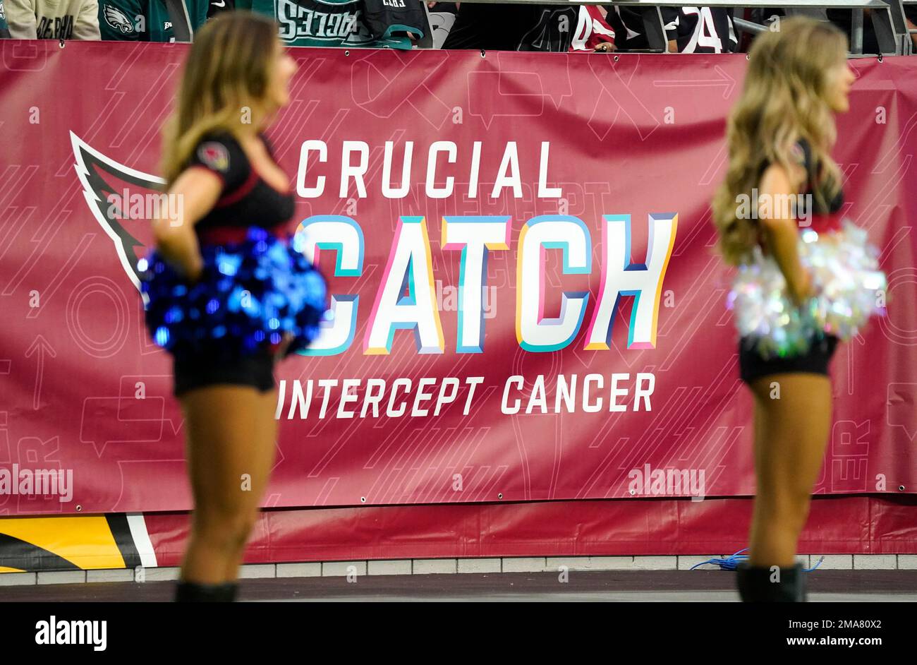 Cheerleaders stand in front of a Crucial catch banner before the first ...
