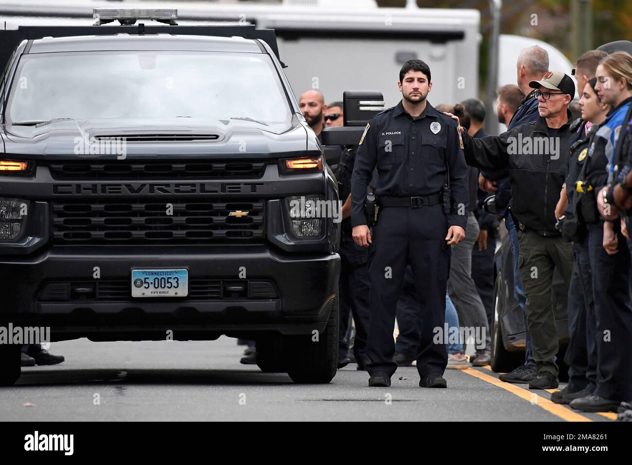 Bristol Police Officer Harrison Pollock is comforted as he stands along ...
