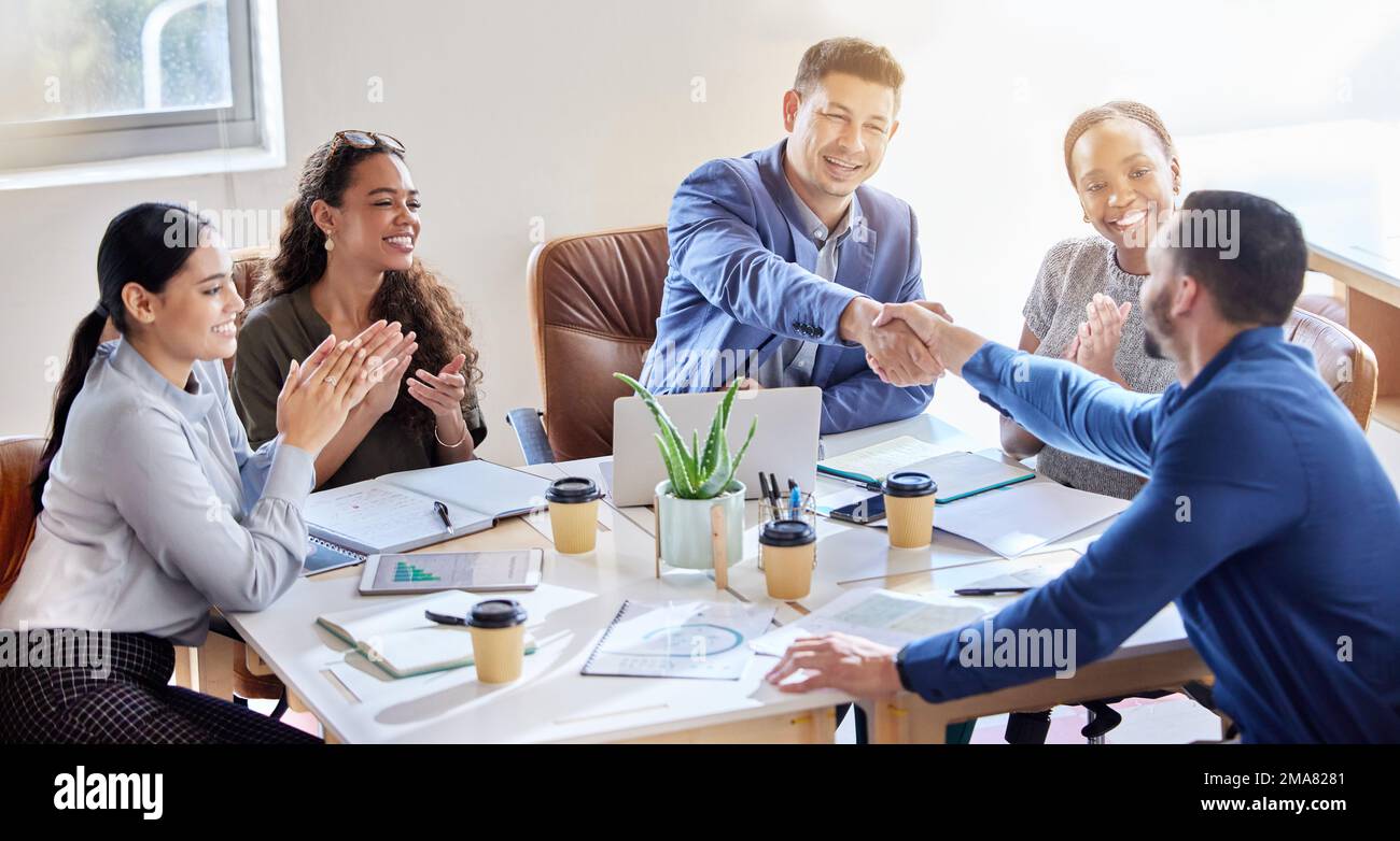 Welcome onboard. a group of colleagues having a meeting in a boardroom ...