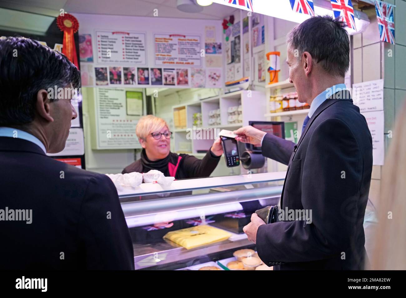 Chancellor Jeremy Hunt (right) purchases pork pies from Slacks Farms as ...