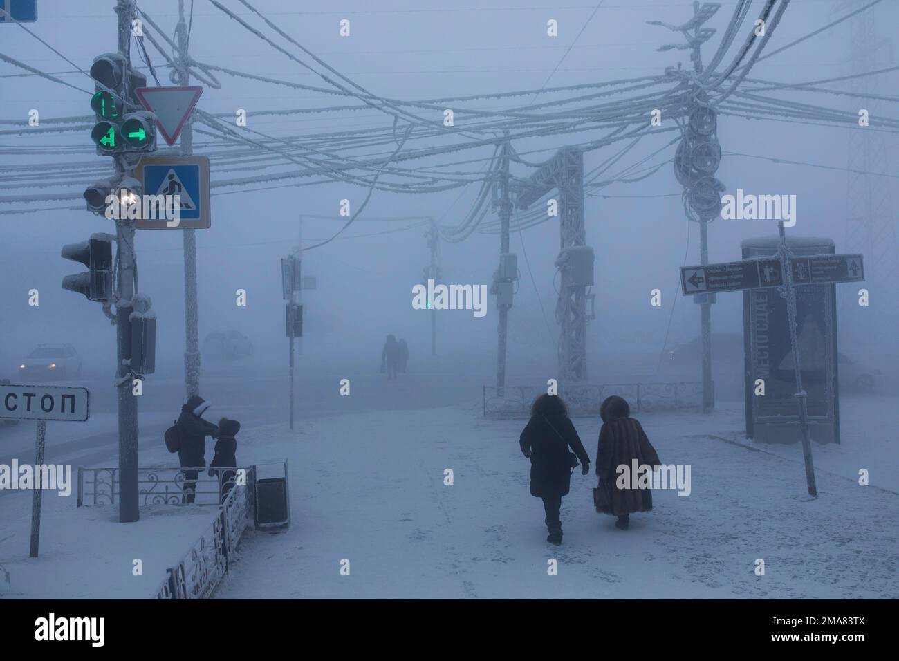 People walk through a frozen street in Yakutsk, eastern Russia ...