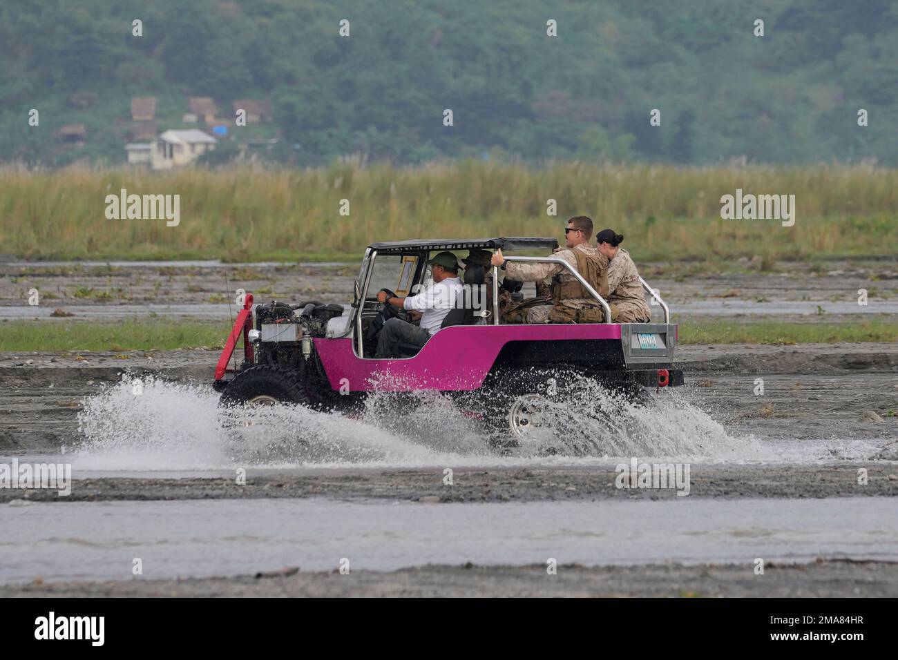 American Marines ride a custom jeepney across a stream during annual ...
