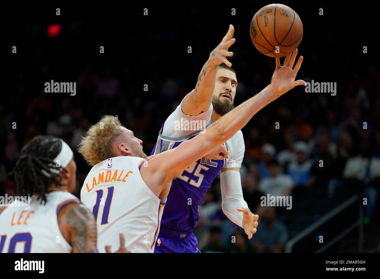 Sacramento Kings center Alex Len (25) and Phoenix Suns center Jock Landale (11) battle for a ...