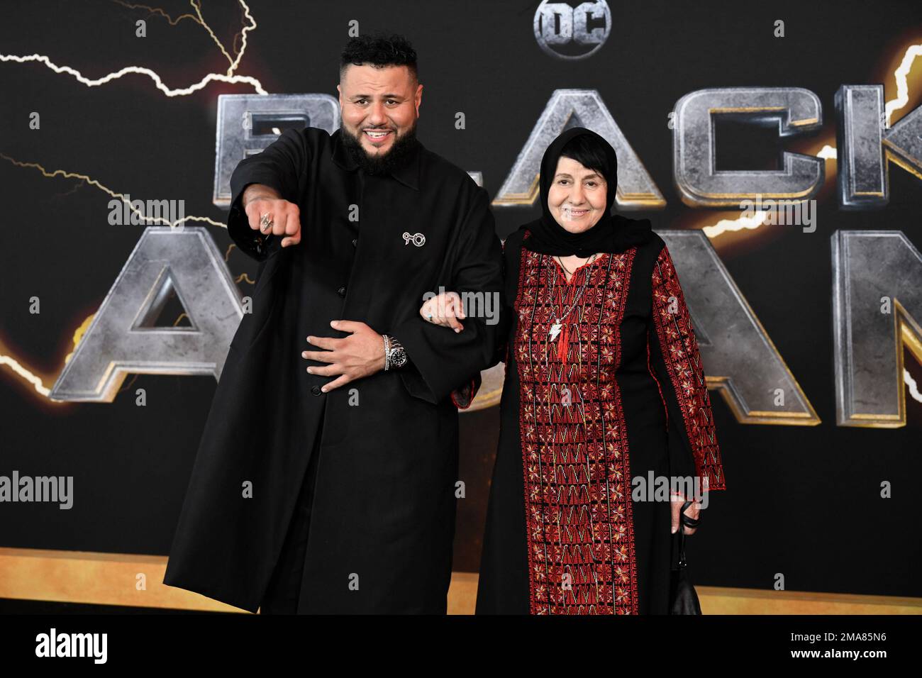 Mohammed Amer, left, and his mother attend the world premiere of "Black Adam" in Times Square on ...