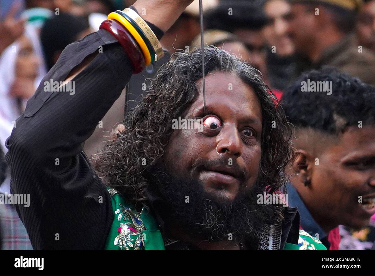 GRAPHIC CONTENT - An Indian ascetic Muslim puts a sharp object into his ...