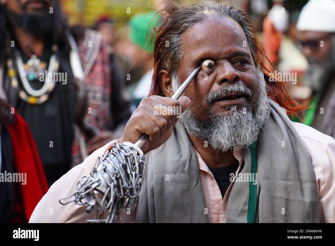 GRAPHIC CONTENT - An Indian ascetic Muslim puts a sharp object into his ...