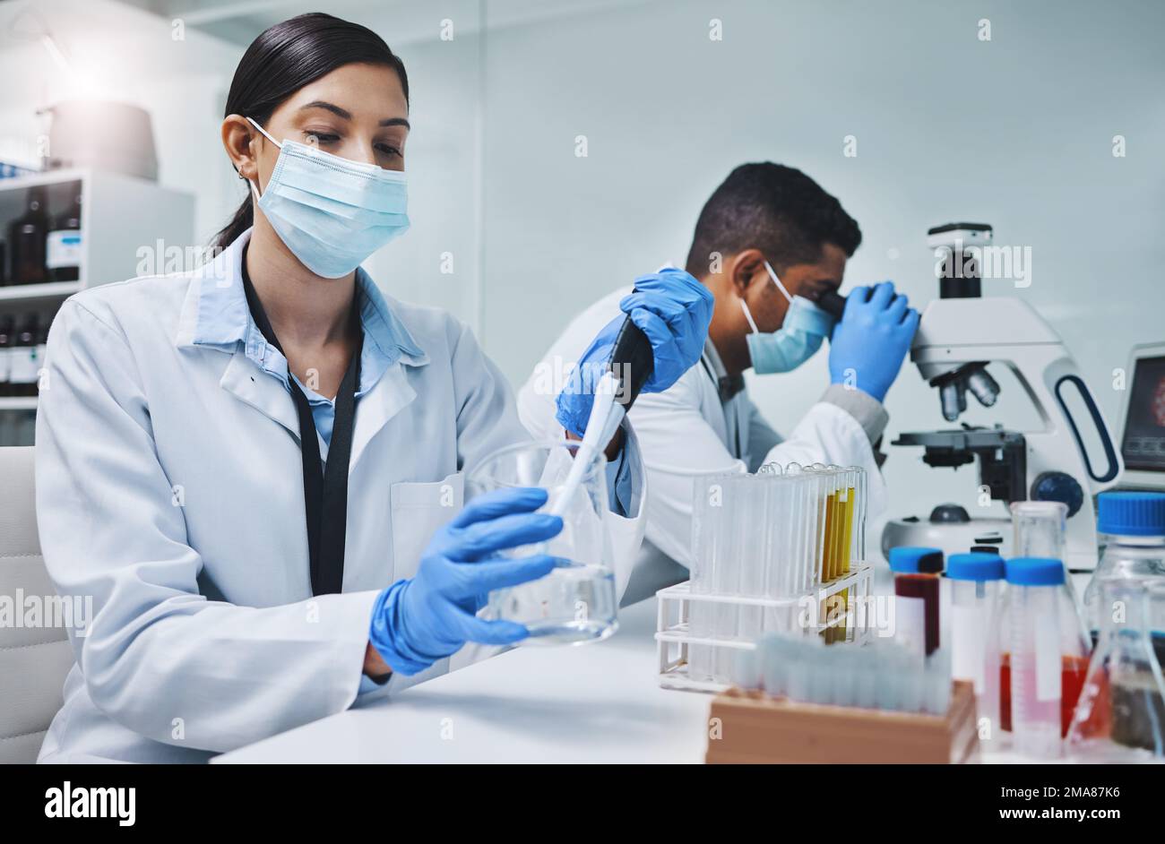 Creating life changing solutions. two young researchers working in a ...