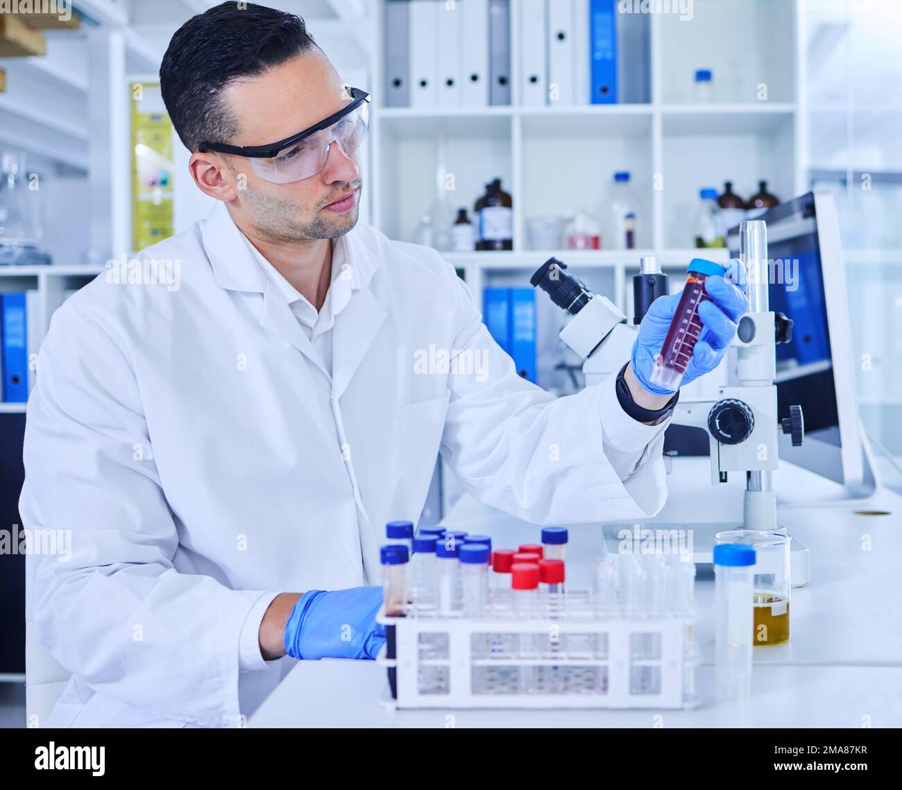 Hows this coming along. a handsome young male scientist working with ...